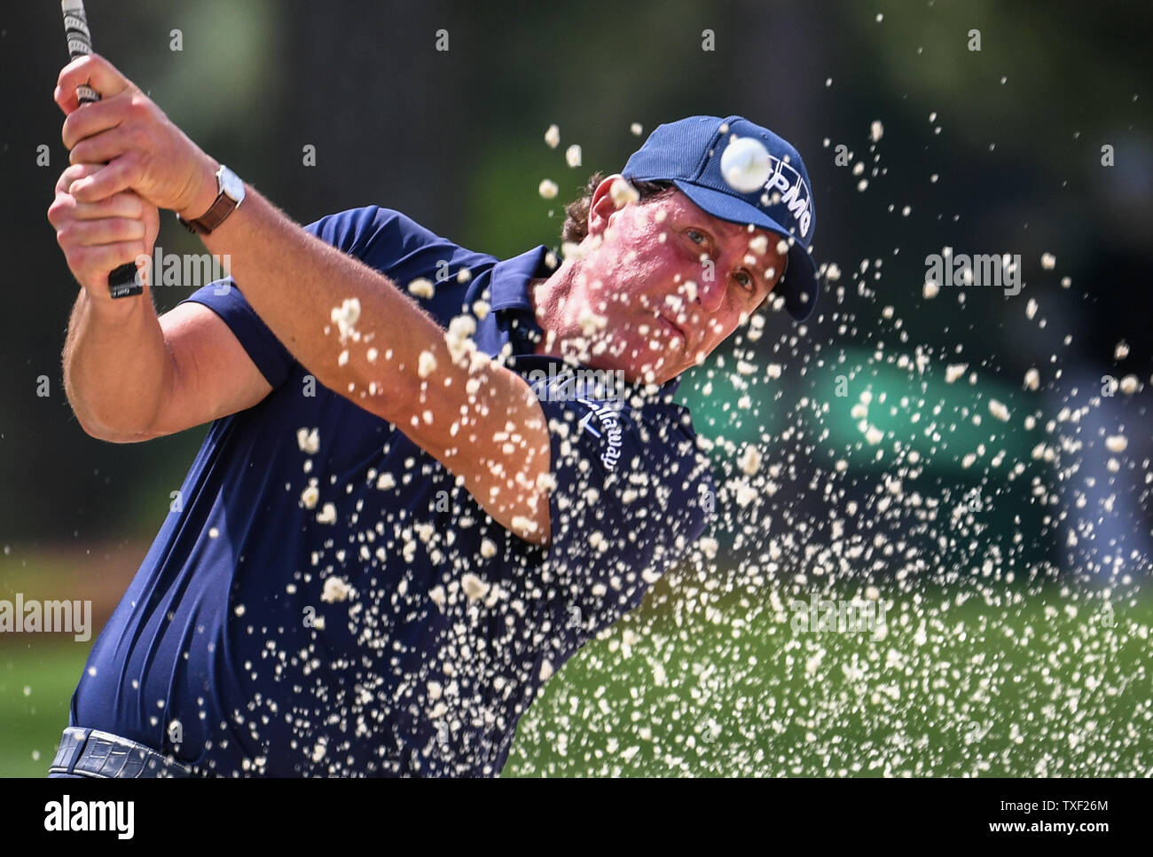 Phil Mickelson hits from a bunker on the 17th hole during the second ...