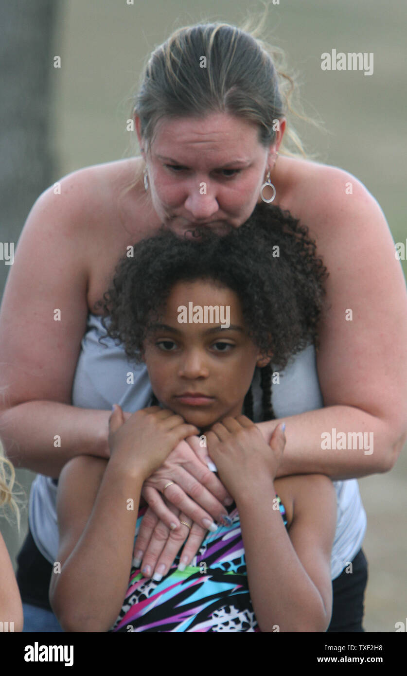 Lisa Klear hugs her daughter Jahlisa, 9, while visiting a makeshift ...