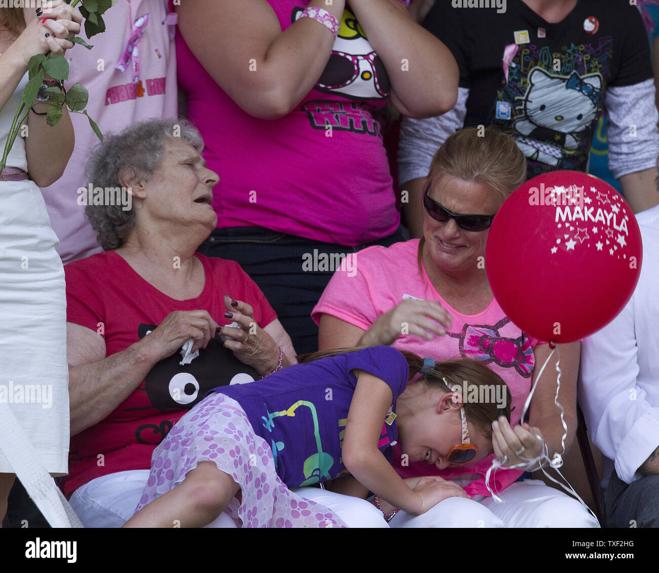 Family members of the victims grieve during a prayer vigil in front of ...