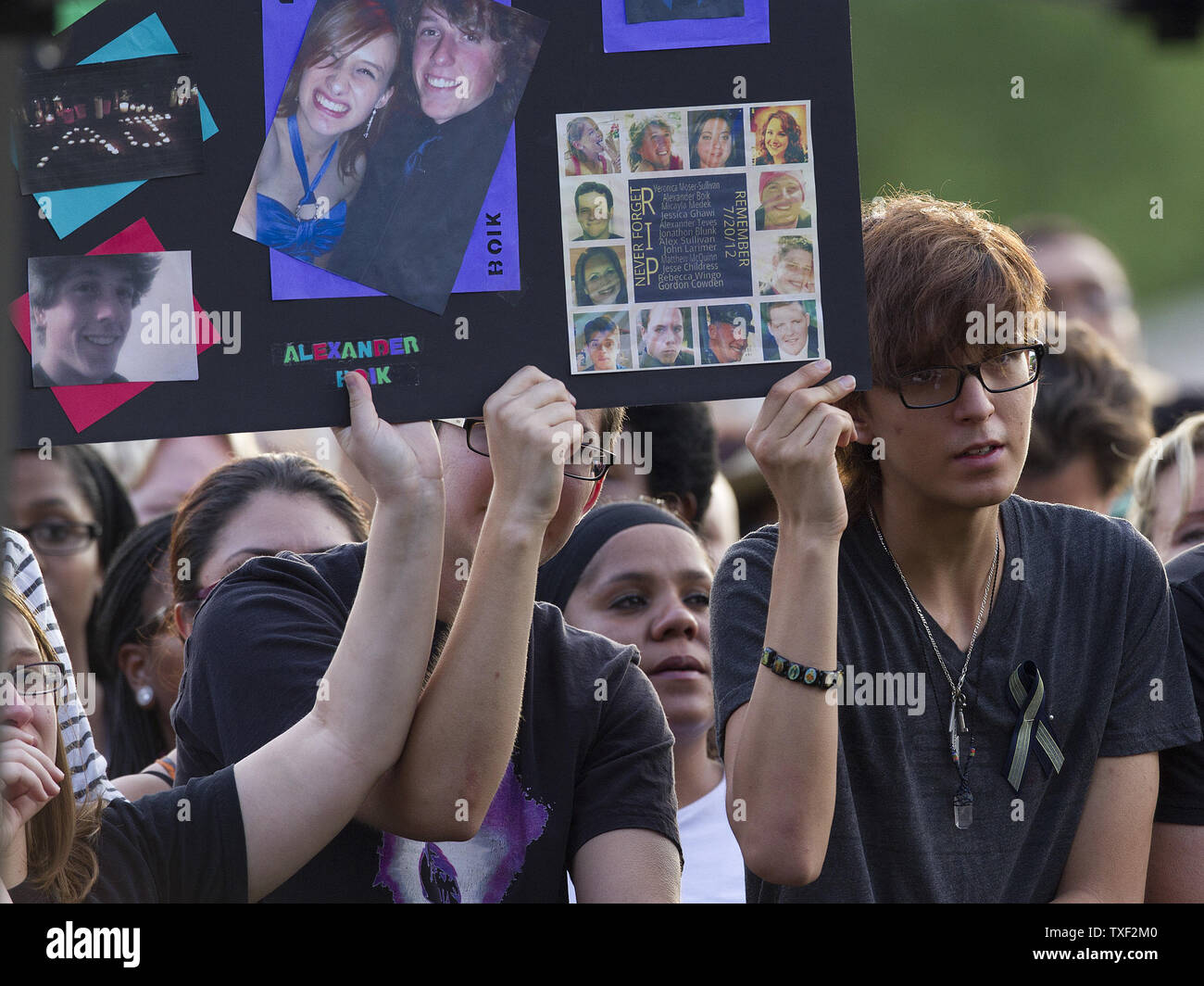 Friends of victim Alexander Boik hold a memorial sign during a prayer ...