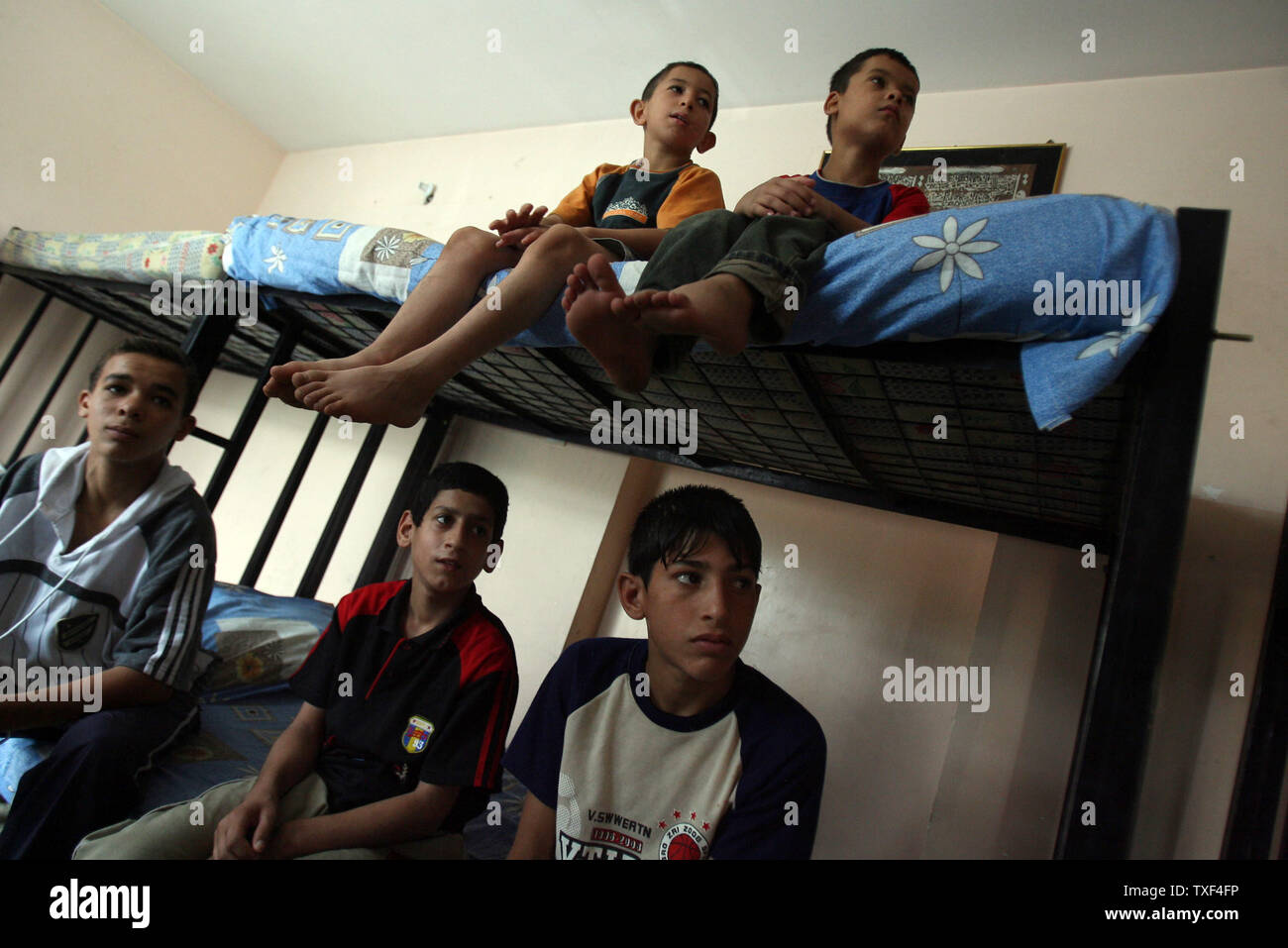 Young Iraqi orphans sit on their beds at the Iraq House, an orphanage ...