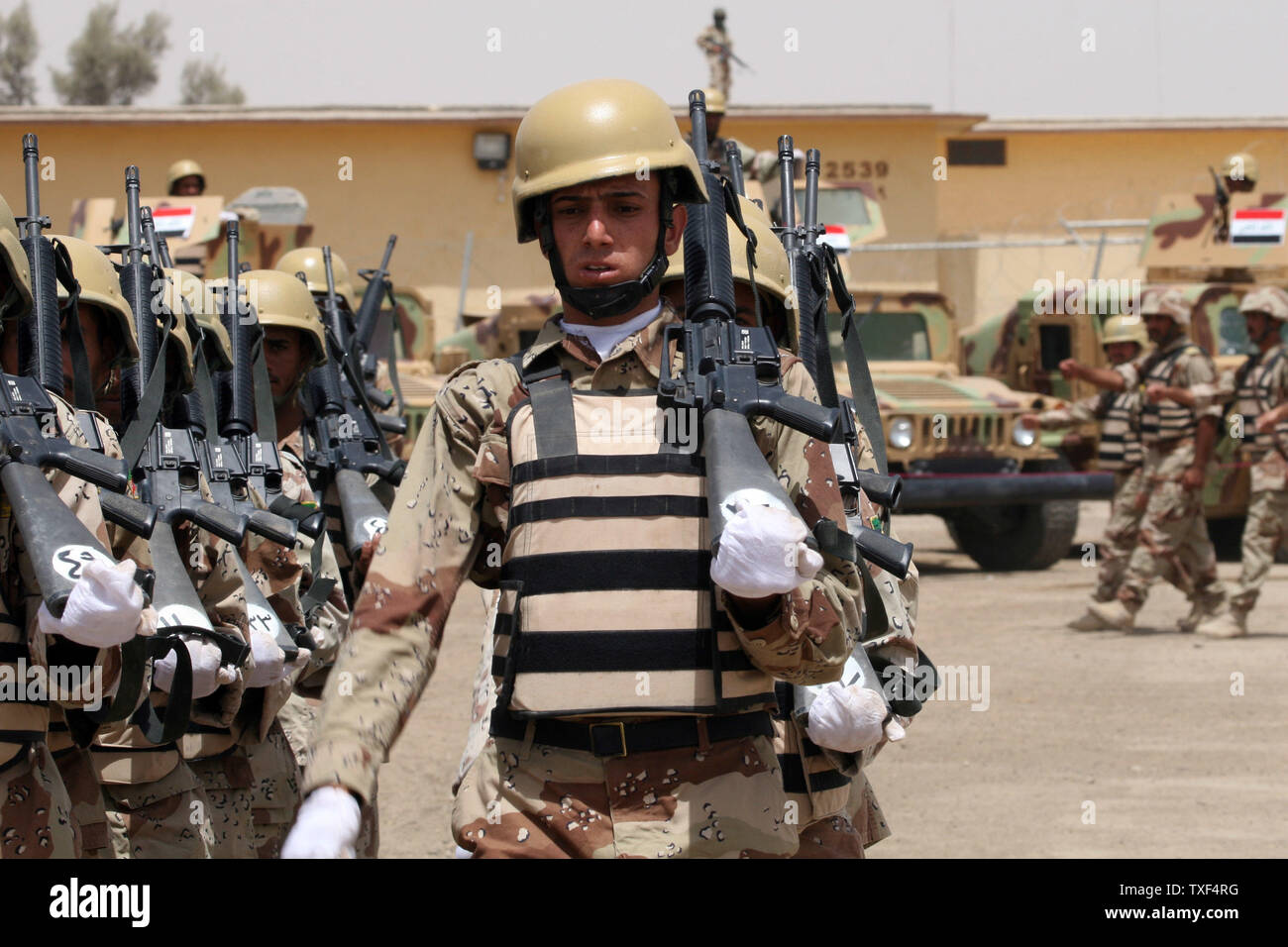 Iraqi soldiers in formation during their graduation ceremony at a ...
