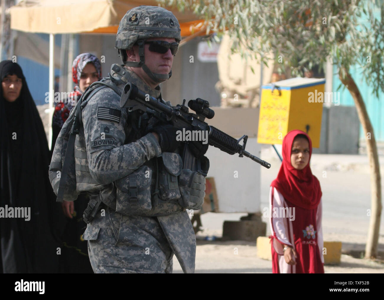 A U.S. soldier patrols a market in Dujail, 80 kilometers (50 miles ...