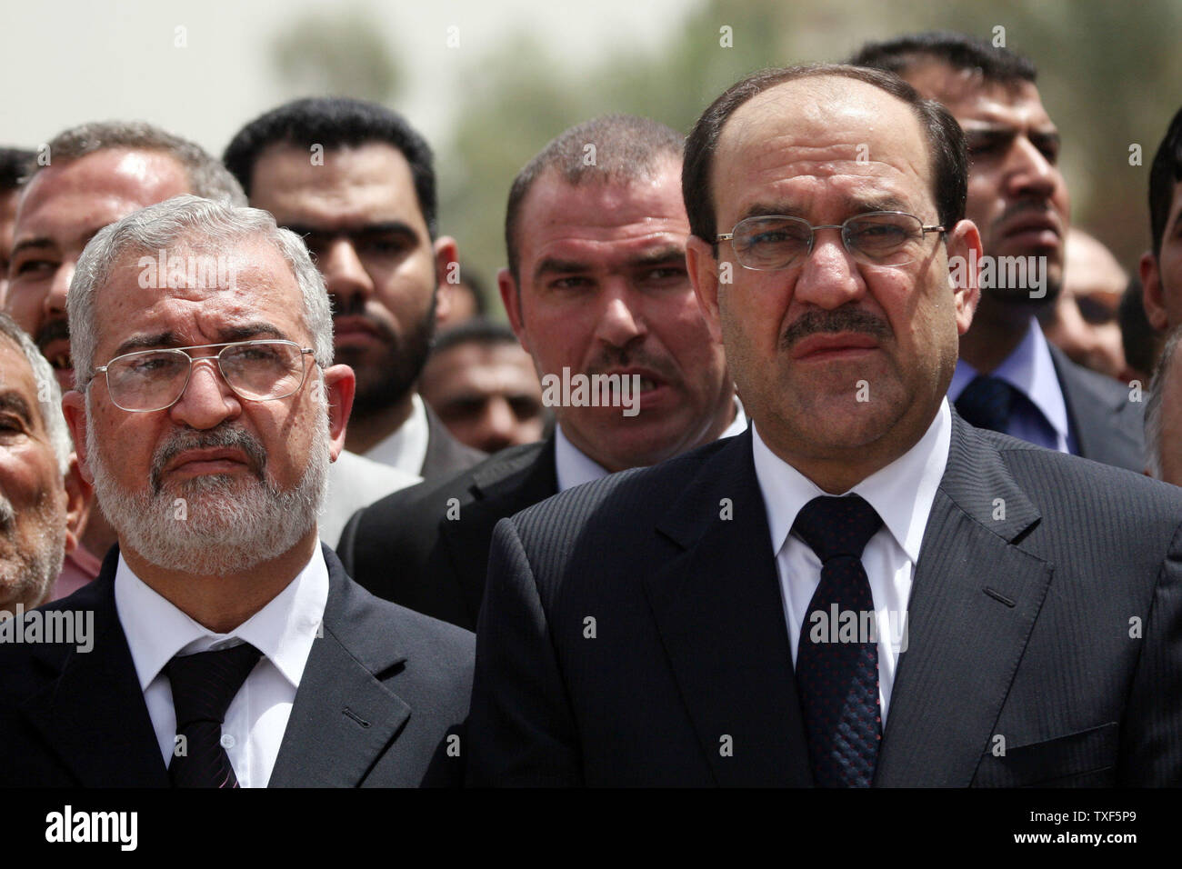 Iraq's Prime Minister Nuri al-Maliki (R) and relatives of Harith al ...