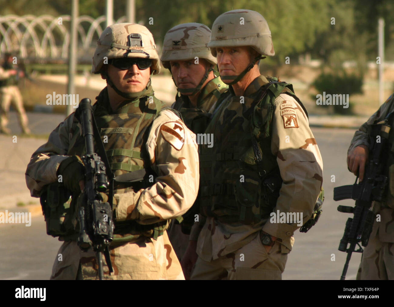 Security surrounds Brig. Gen. Mark Kimmitt as he surveys the damage at ...