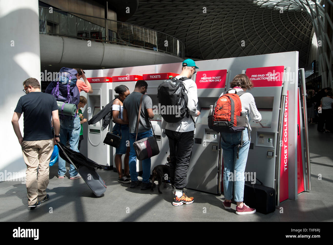 London, Kings Cross.Station forecourt. People buying and collecting ...