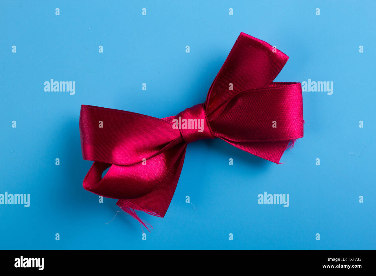 dark red ribbon on the blue background Stock Photo - Alamy