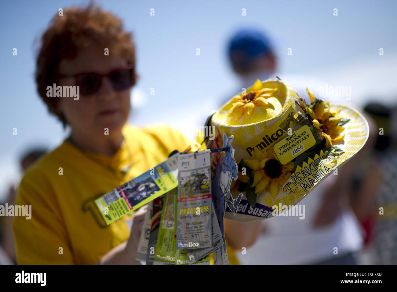 Betty Alexa, of Erie, Pennsylvania, adjusts her hat as she watches ...