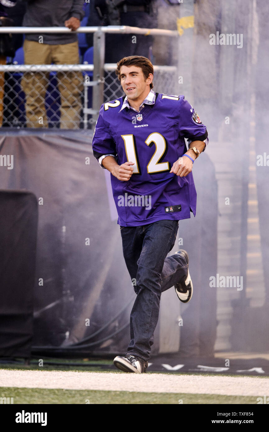 U.S. Olympic Swimmer Michael Phelps runs out on the field as an ...