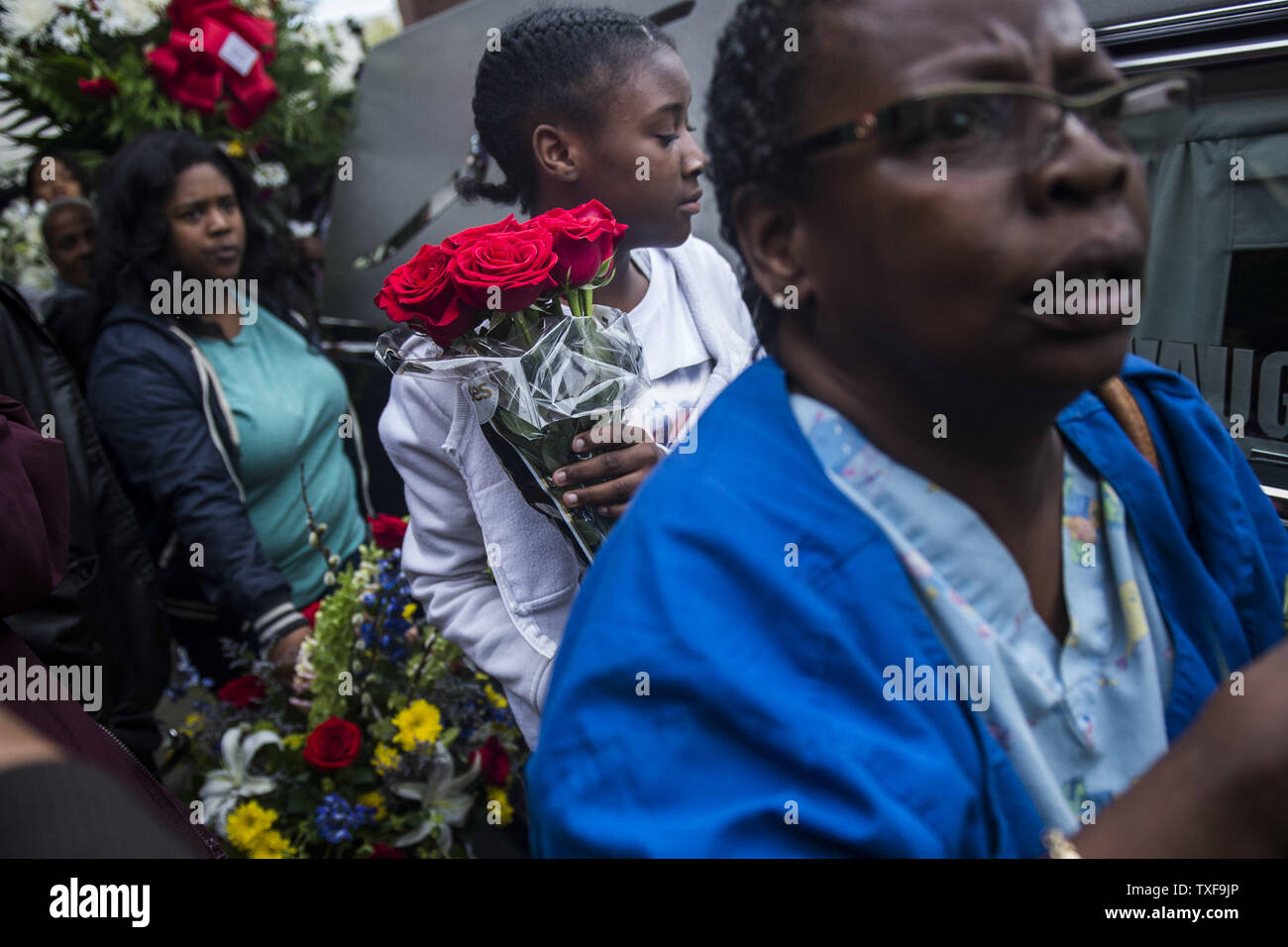 Women carry flowers out to the hearse after the funeral for Freddie ...