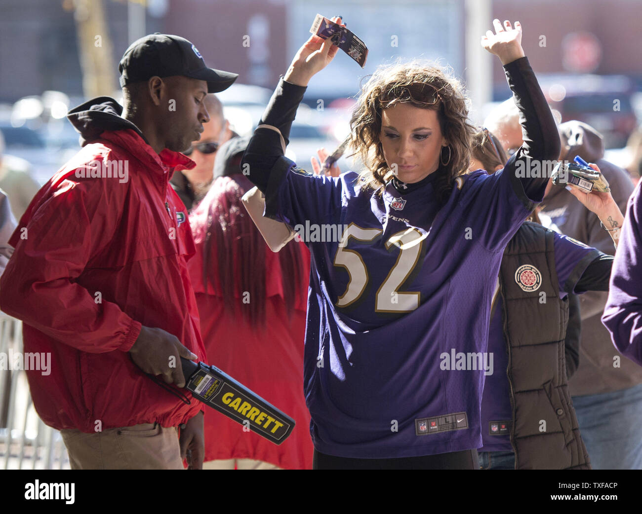 A Baltimore Ravens fan goes through security before the Ravens game ...
