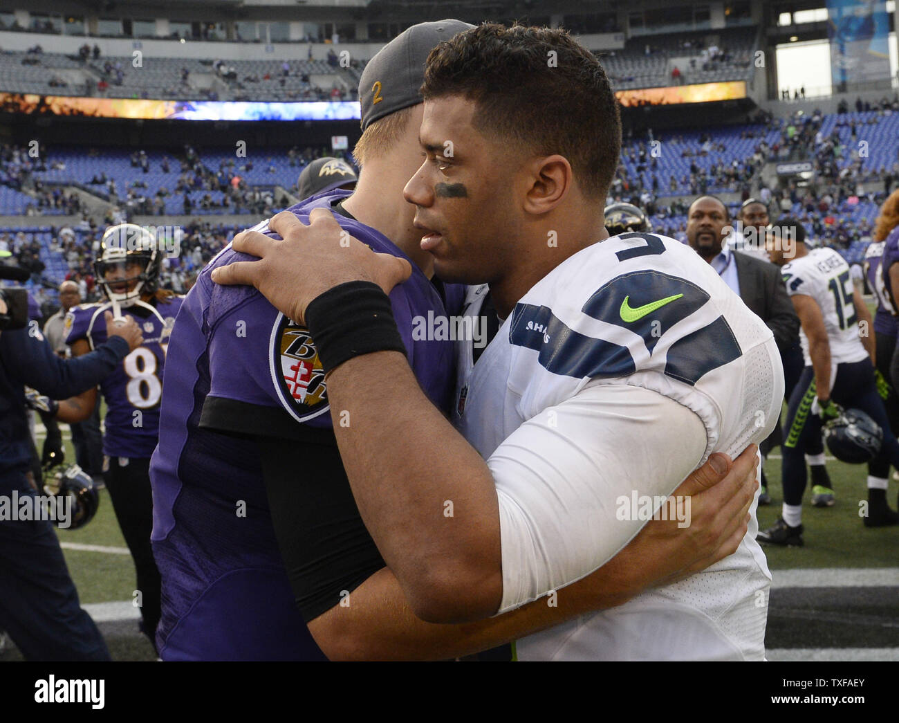 Seattle Seahawks quarterback Russell Wilson (3) hugs Baltimore Ravens ...