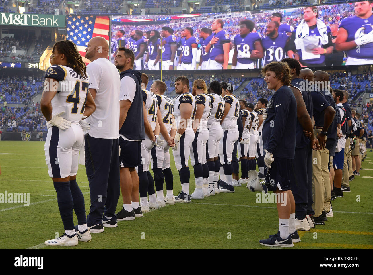 Los Angeles Rams and Baltimore Ravens players stand for the National ...