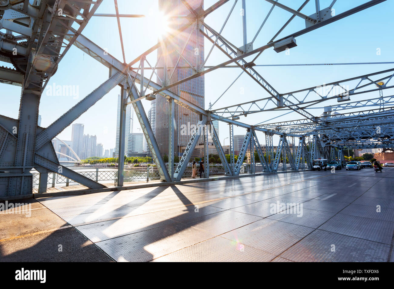 Traffic on steel bridge interior and skyline at sunset Stock Photo - Alamy