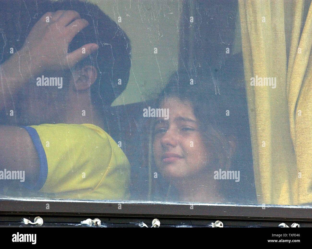 A Swedish girl is in tears as she is evacuated by bus from centerl ...