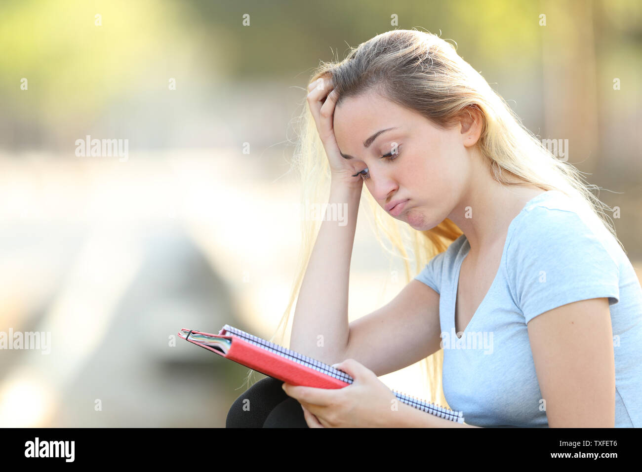 Frustrated student trying to learn lesson reading notes sitting in a ...