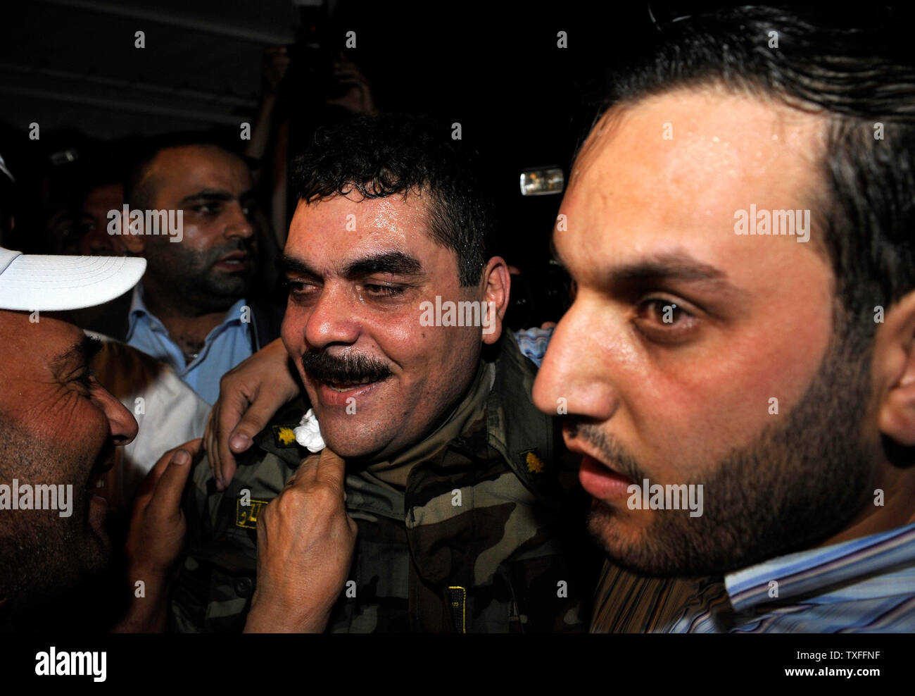 Released prisoner Samir Qantar is greeted by his brother Bassam (R) at ...