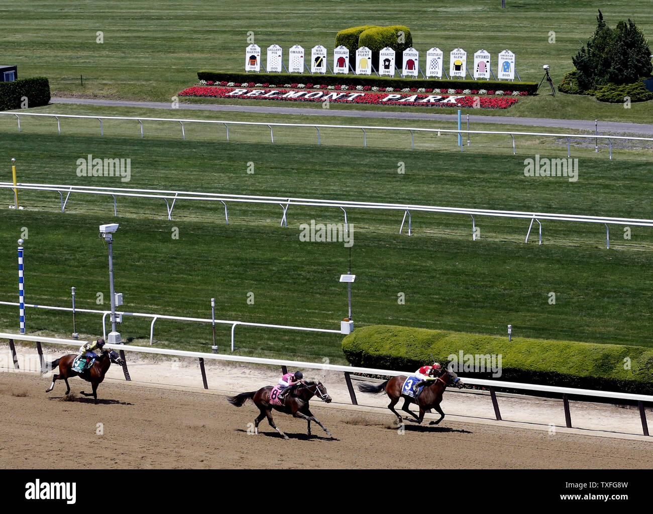 Horses head down the stretch in an early race on Belmont Stakes day at ...