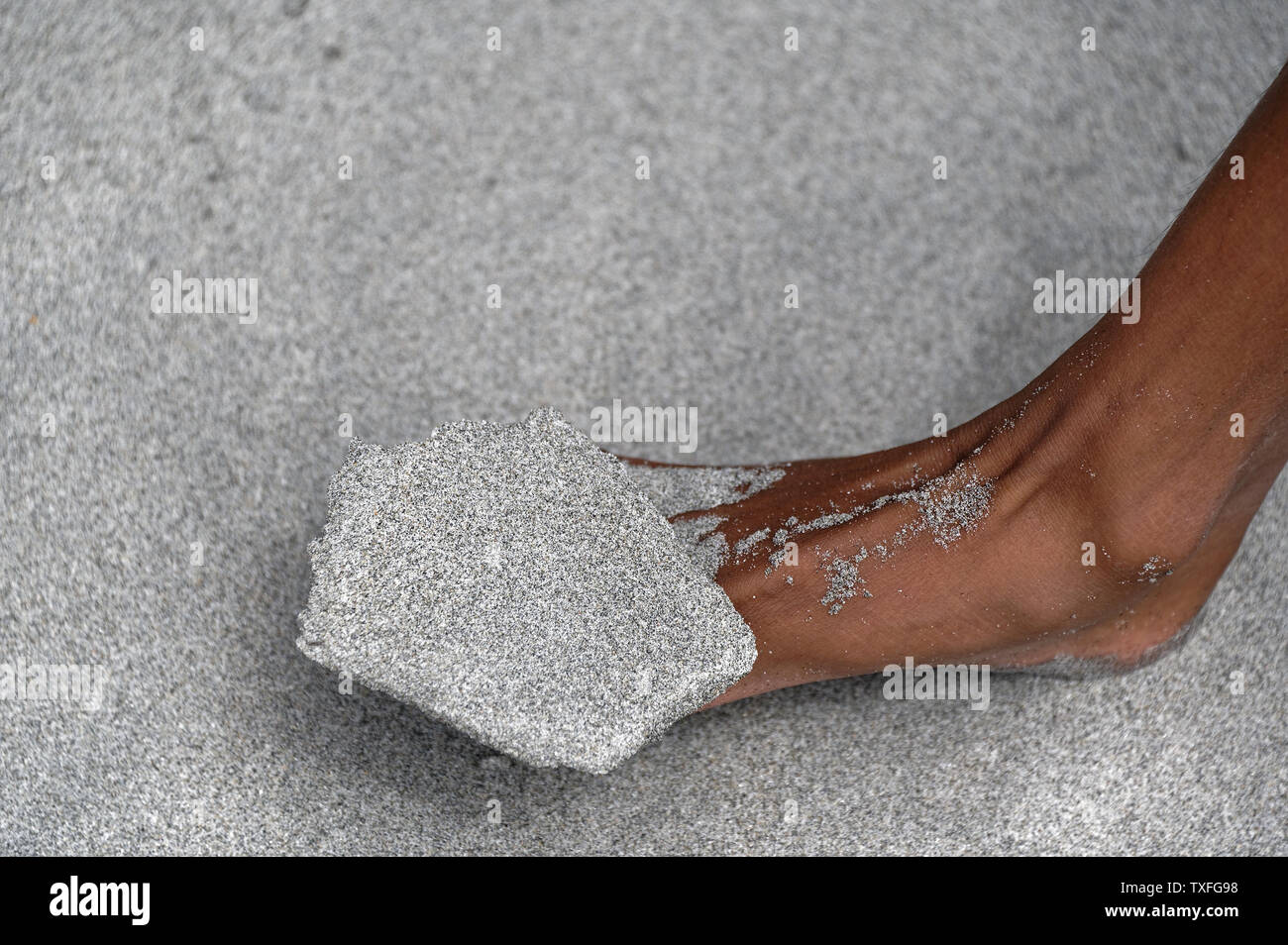 Sand balancing on someone's foot at the beach Stock Photo - Alamy