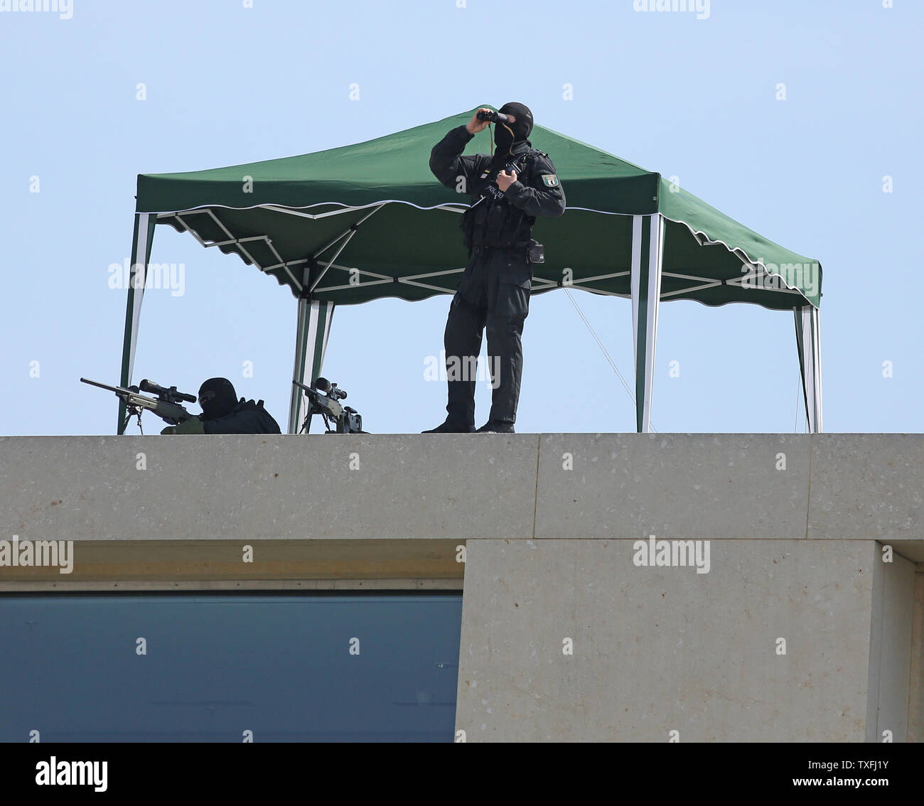 German security guards are seen on a roof before a speech by U.S ...
