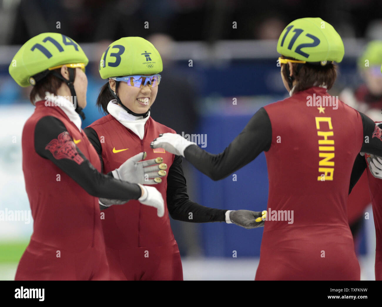 China's Yang Zhou (L), Hui Zhang (C) and Meng Wang skates celebrate ...