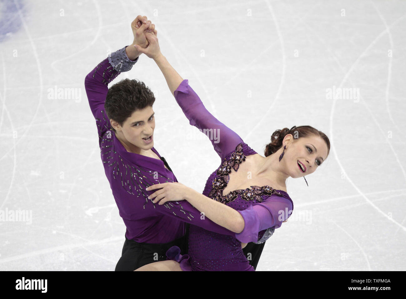Vanessa Crone (R) and Paul Poirier of Canada skate the compulsory ice ...