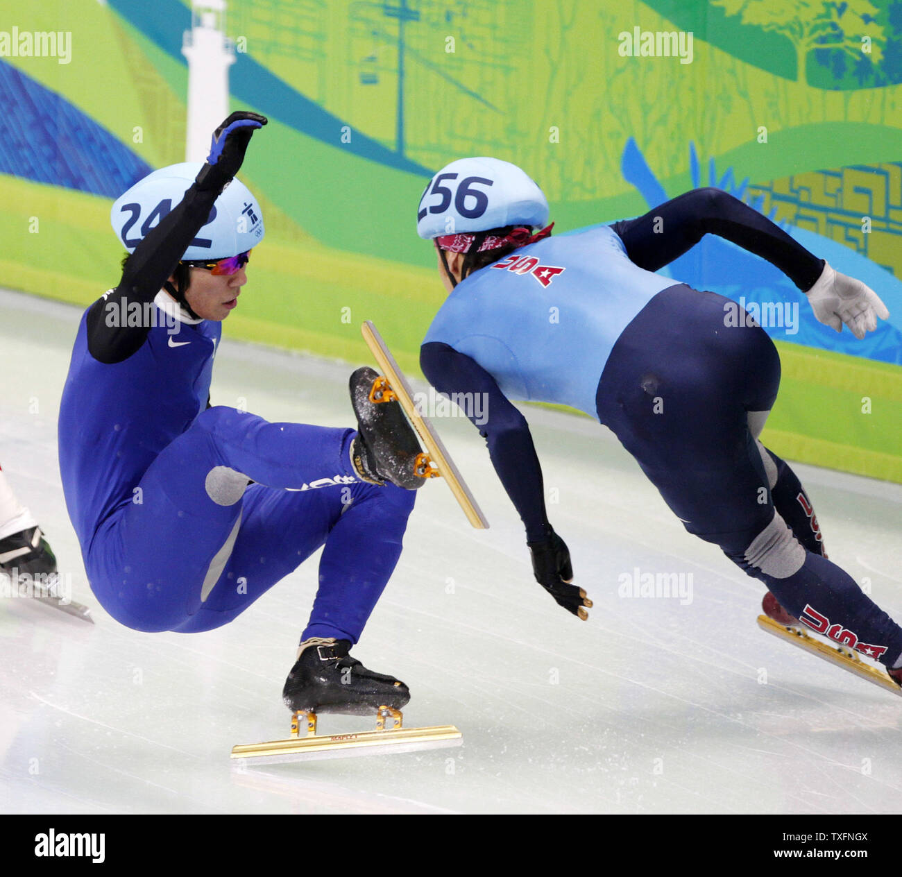 Lee Ho-Suk of the Republic of Korea (L) falls as he skates with Apolo ...