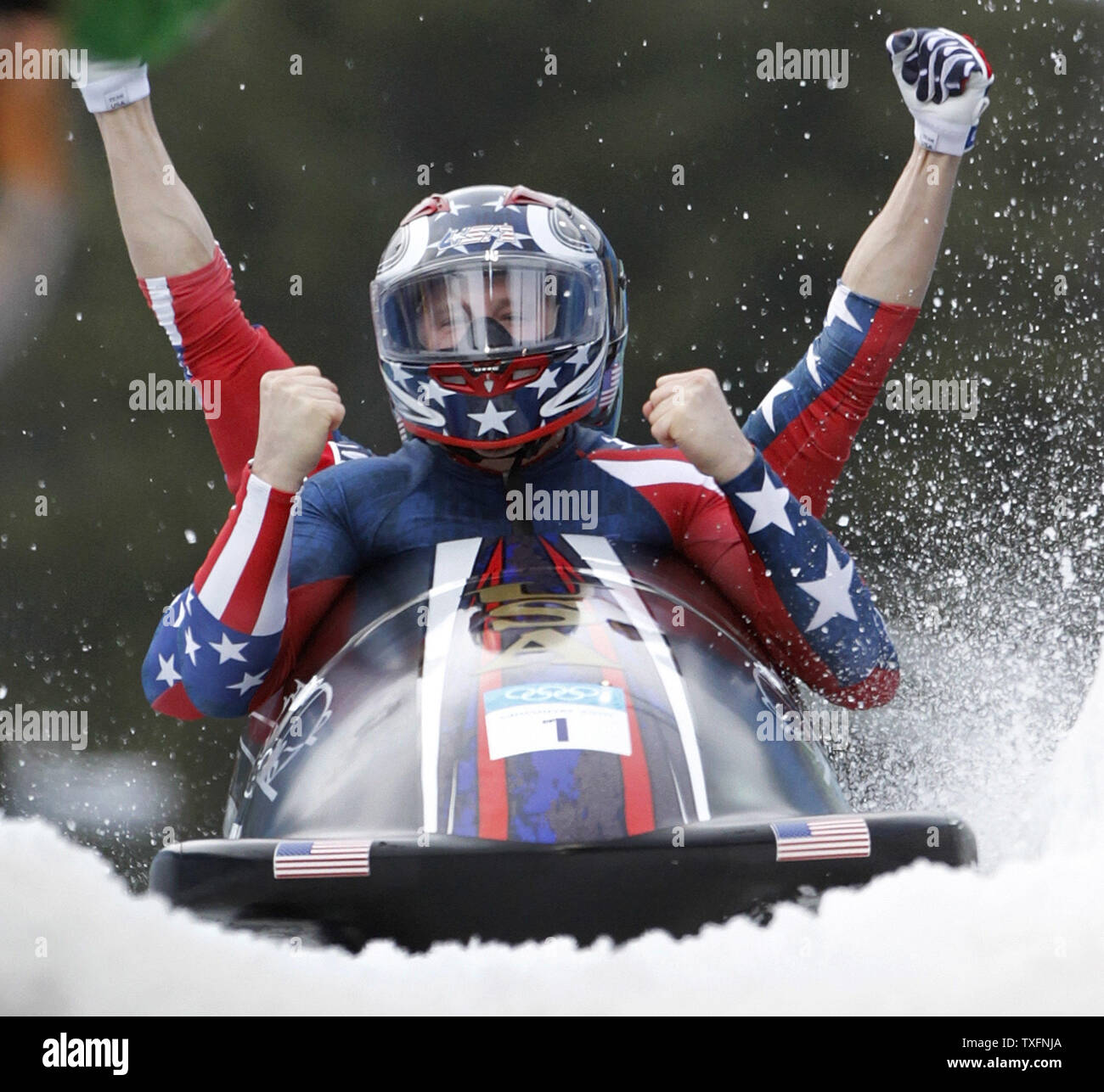 The USA 1 four-man bobsleigh team driver Steven Holcomb celebrates as ...