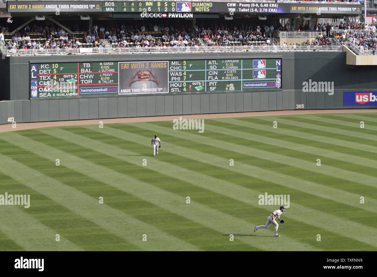 A scoreboard shows scores from around the league on Opening Day at ...