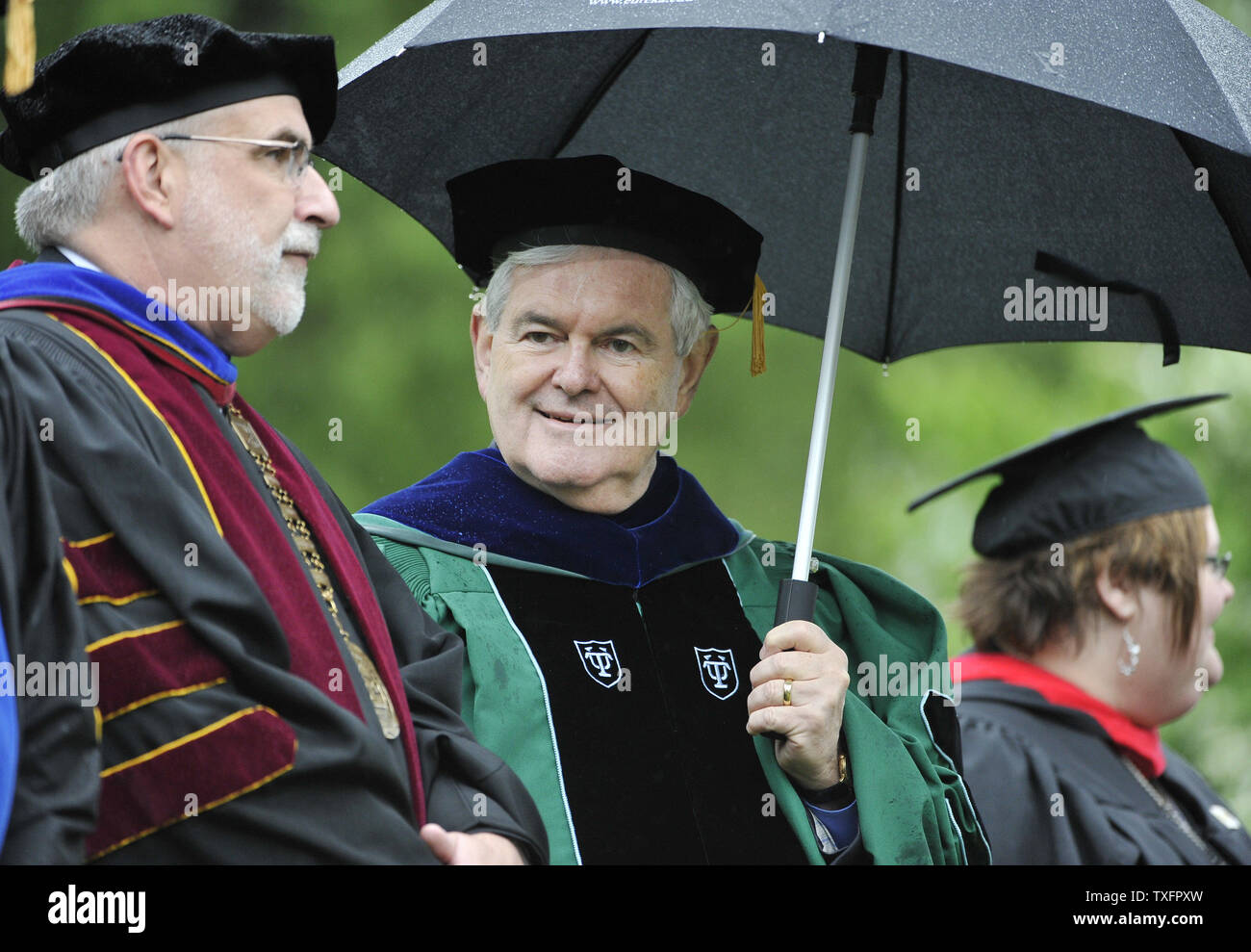 Newt Gingrich (C) smiles as he stands with Eureka College president J ...