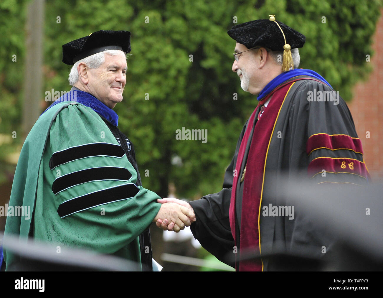 Newt Gingrich (L) shakes hands with Eureka College President J. David ...