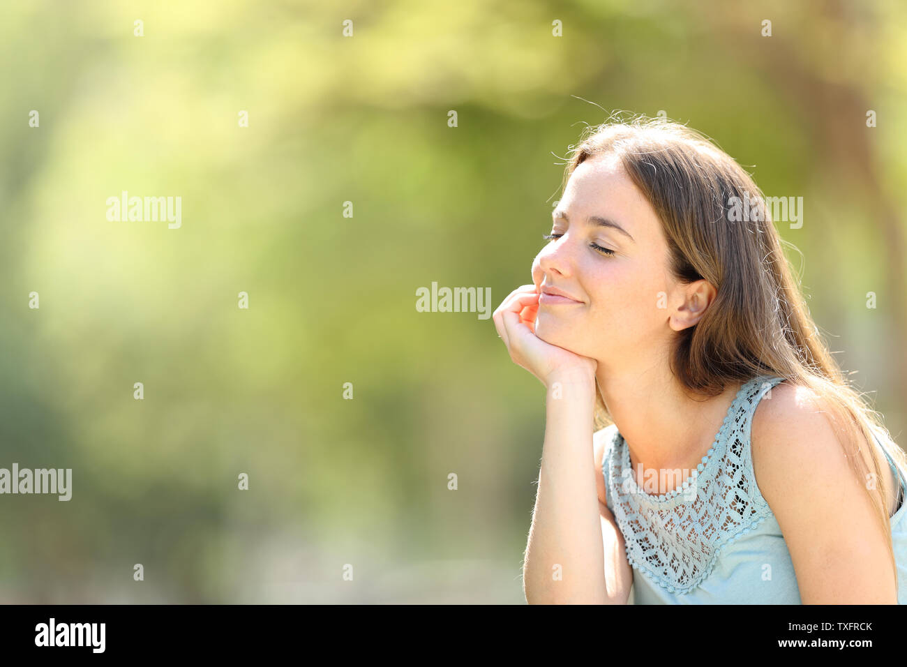 Smiley woman meditating and relaxing with closed eyes in a forest Stock ...