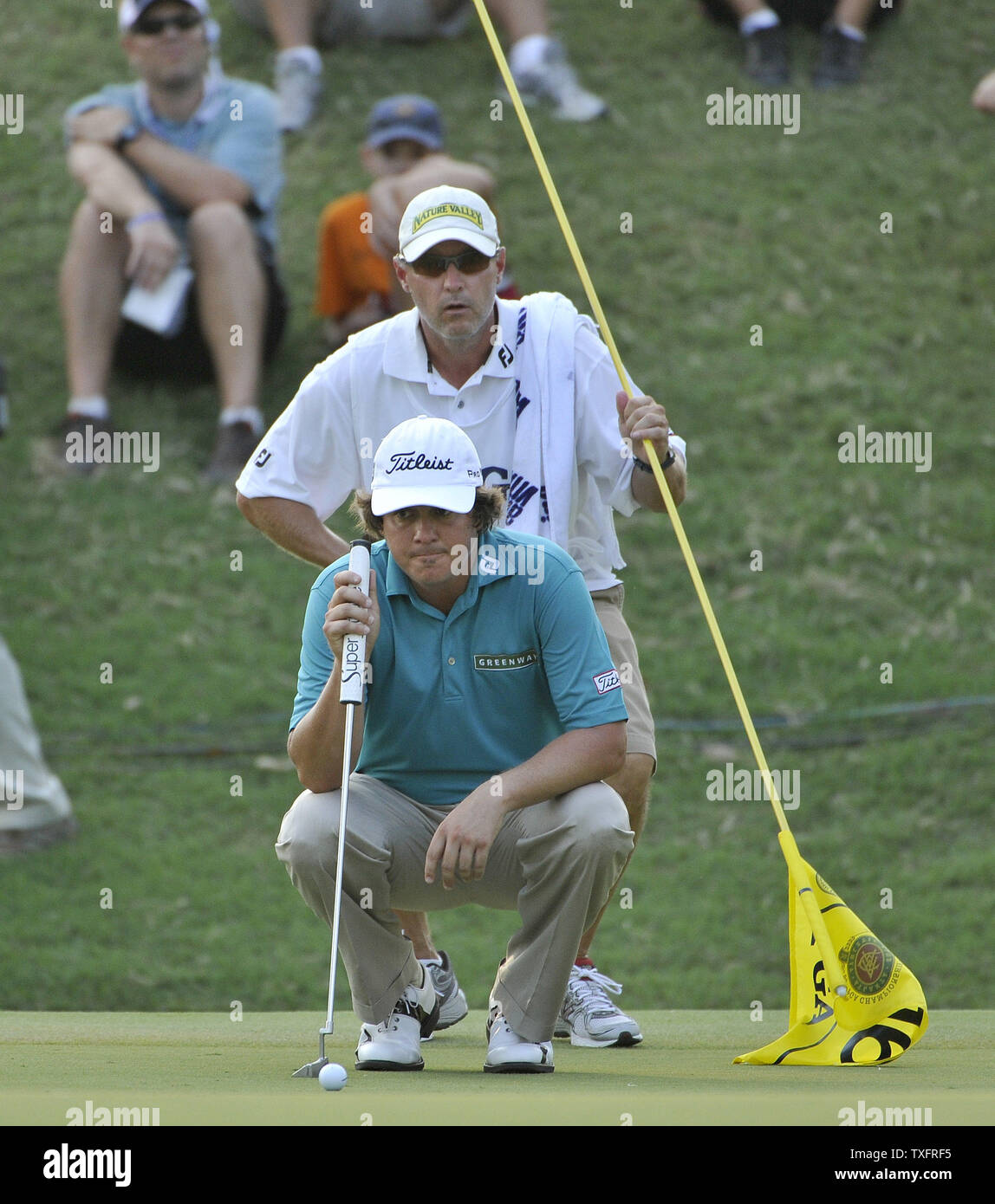 Jason Dufner (front) and his caddie Kevin Baile line up his putt on the ...