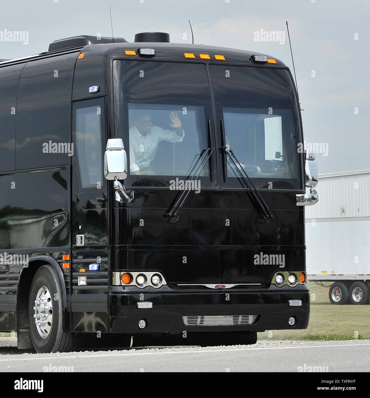 U. S. President Barack Obama waves to onlookers through the window of a ...