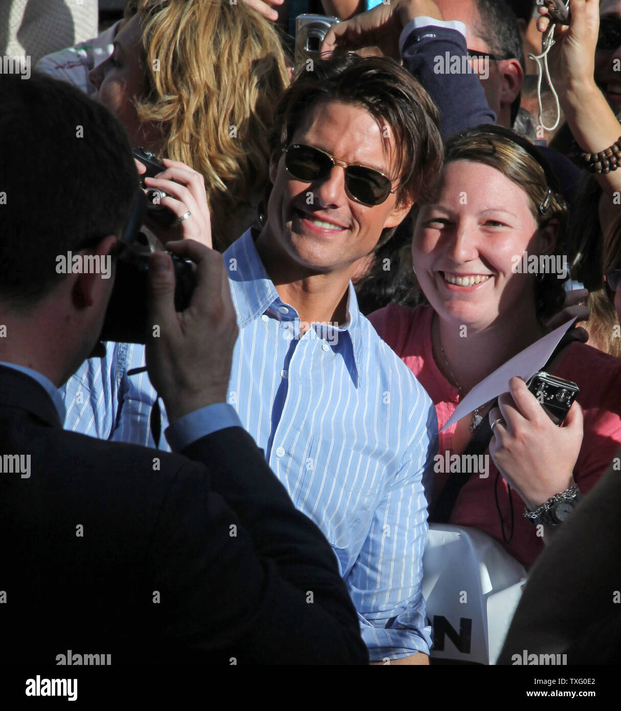 Tom Cruise poses for a photo with a fan at the French premiere of the ...