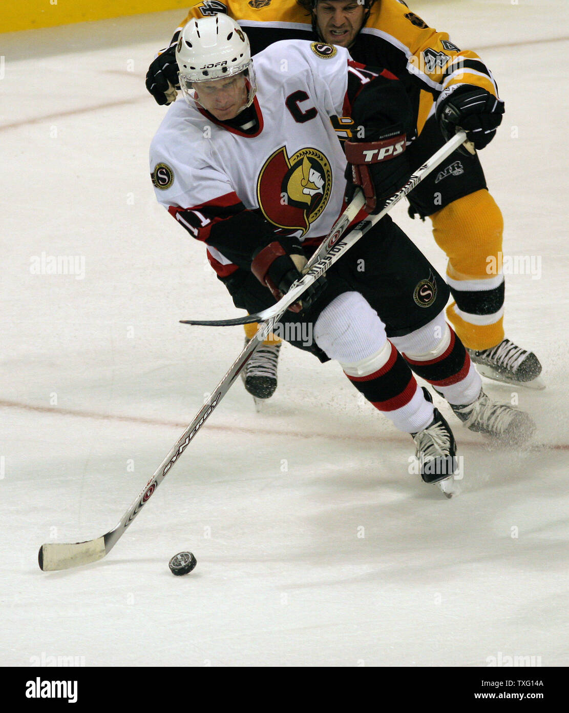 Ottawa Senators P.J. Axelsson races ahead of Boston Bruins Nick Boynton ...