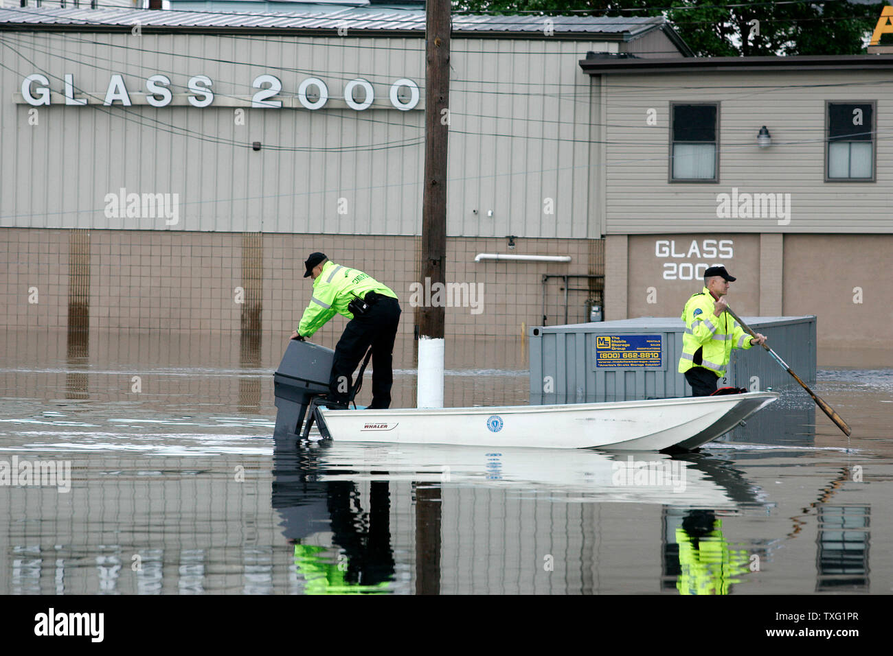 Members of the Massachusetts State Police survey the flooding around ...