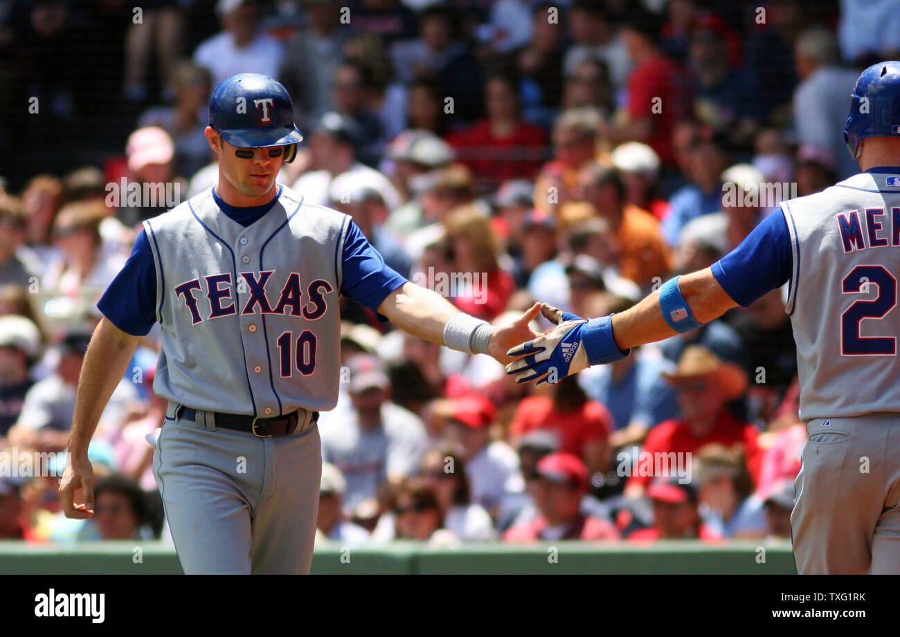 Texas Rangers shortstop Michael Young slaps hands with designated ...