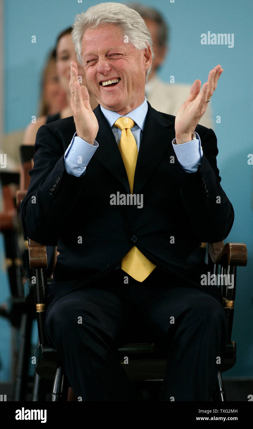 Former President Bill Clinton laughs at a joke from Harvard College ...