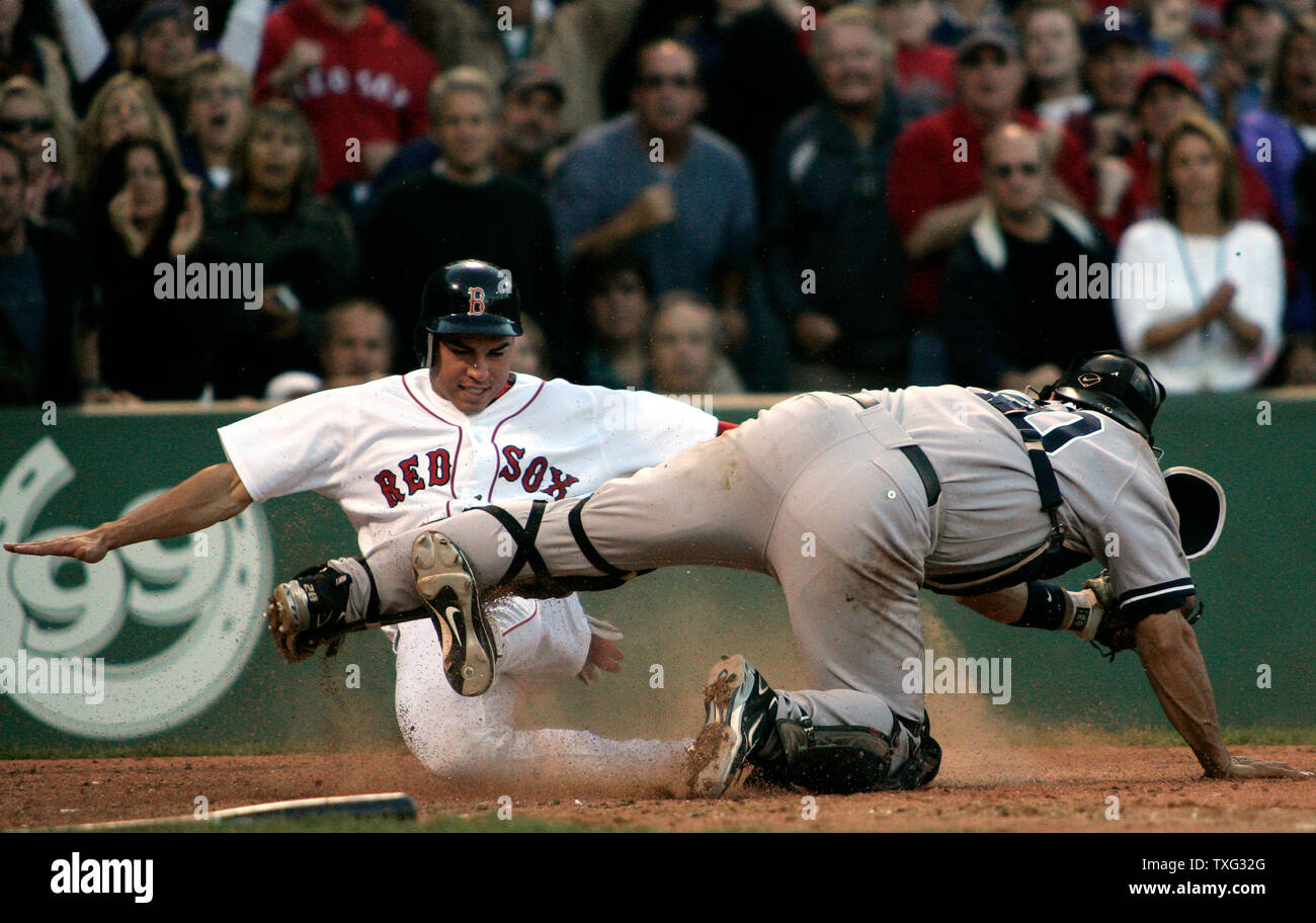 Boston Red Sox left fielder Jacoby Ellsbury (L) slides safely into home ...