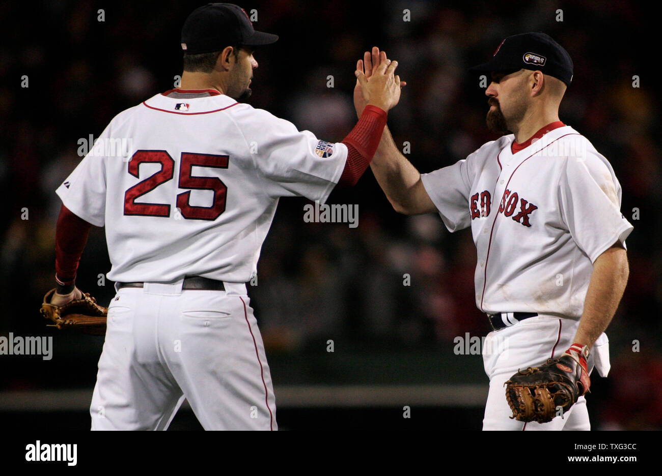 Boston Red Sox first baseman Kevin Youkilis (R) gives a high five to ...
