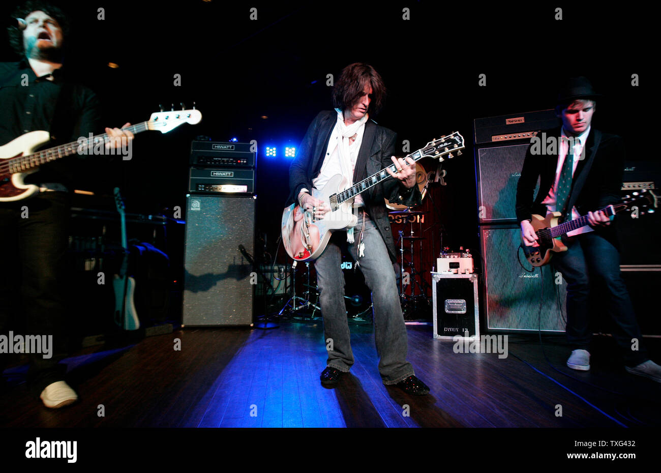 Joe Perry of the band Aerosmith (C) performs with his two sons Tony ...