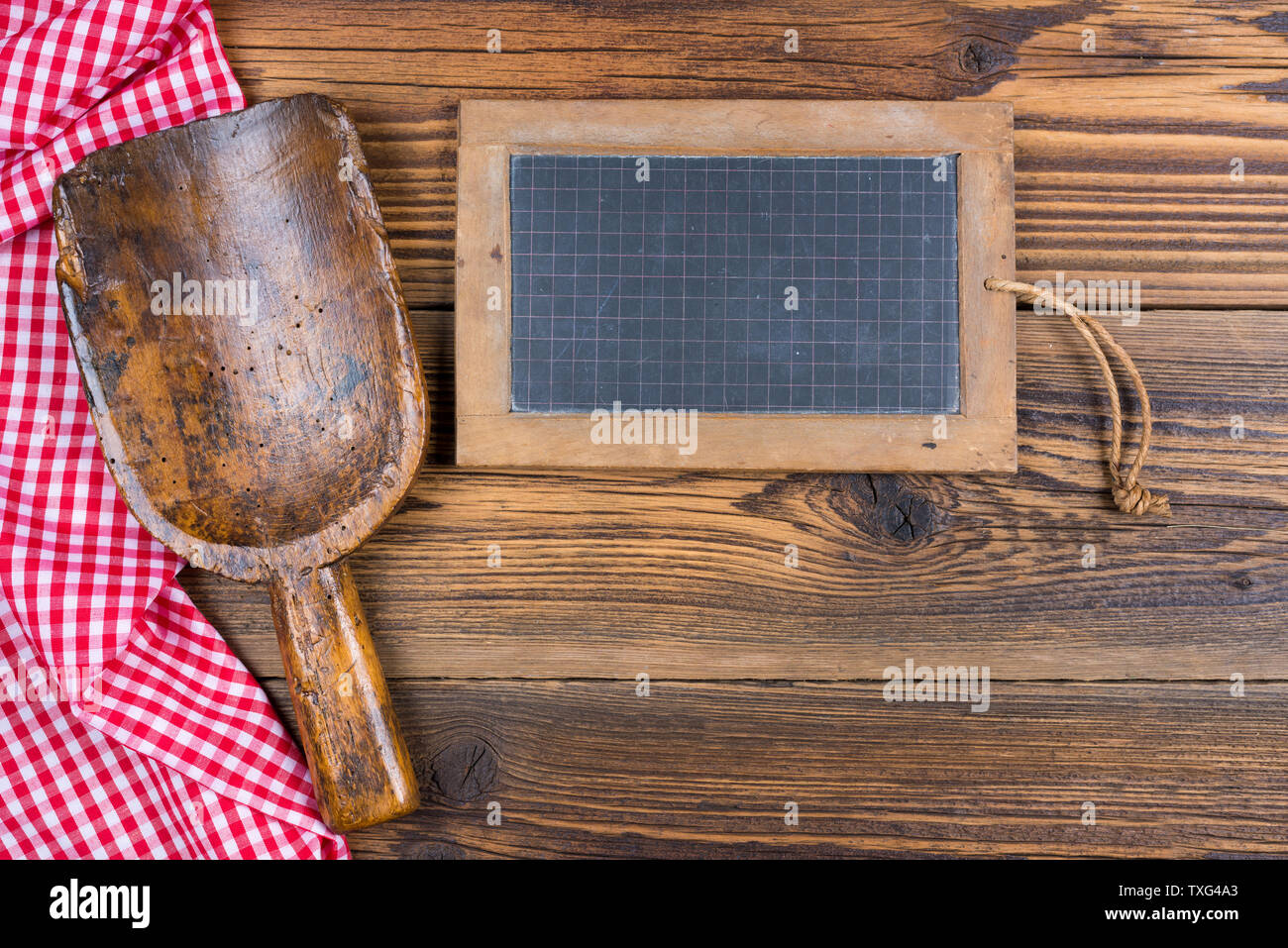 An old slate board and an old flour shovel as well as a red and white ...