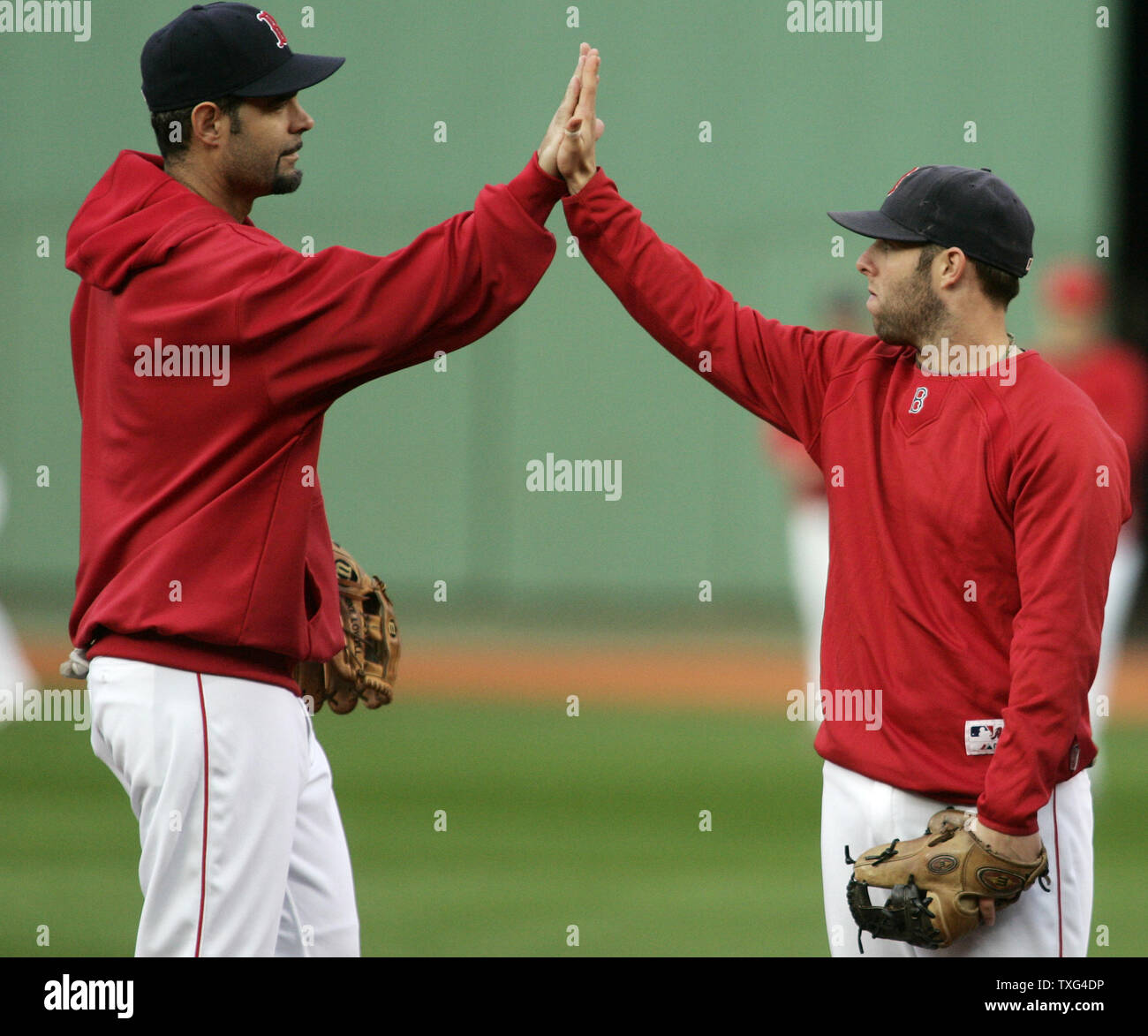 Boston Red Sox Mike Lowell (L) gives a high five to teammate Dustin ...
