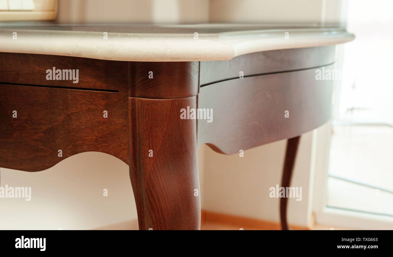 Wooden table with stone top. Classical form. Closeup Stock Photo - Alamy