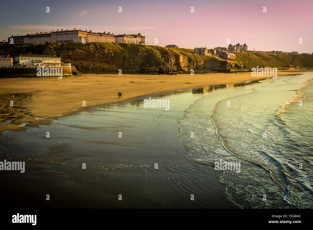 WHITBY in ENGLAND. People walking on Whitby beach on a fine sunny ...