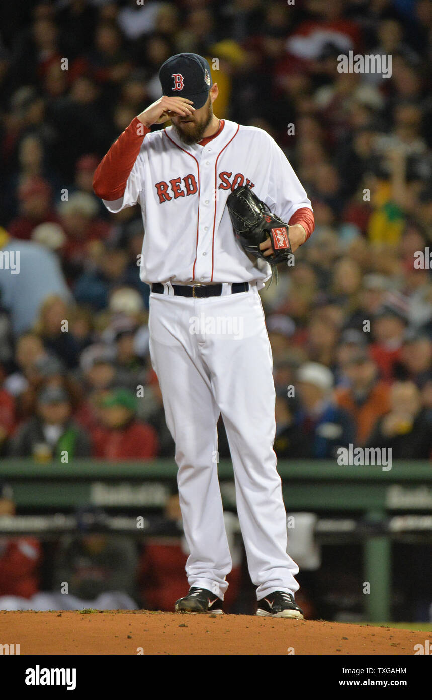 Boston Red Sox starting pitcher John Lackey reacts to giving up a ...