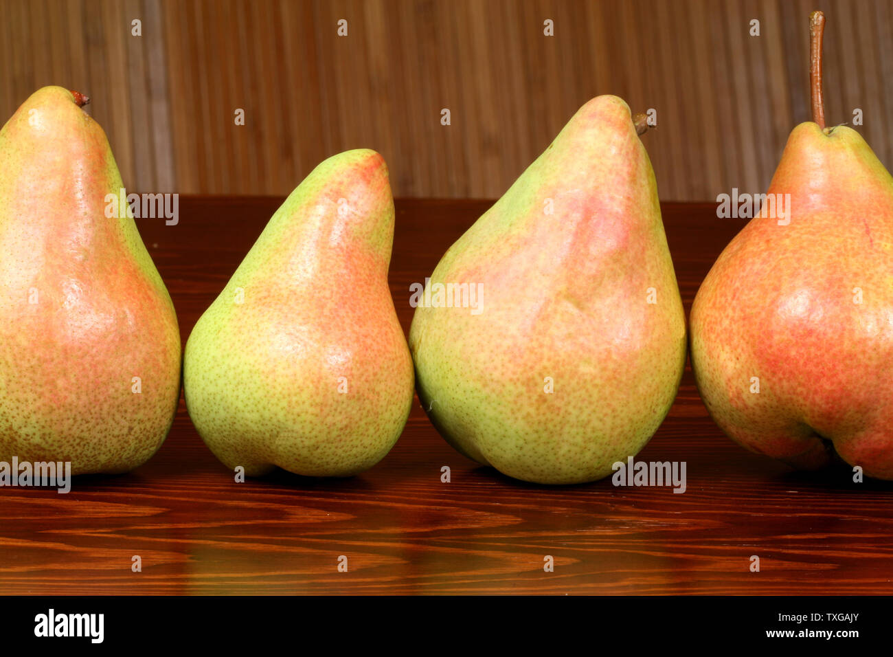Four fresh pears on the table Stock Photo - Alamy