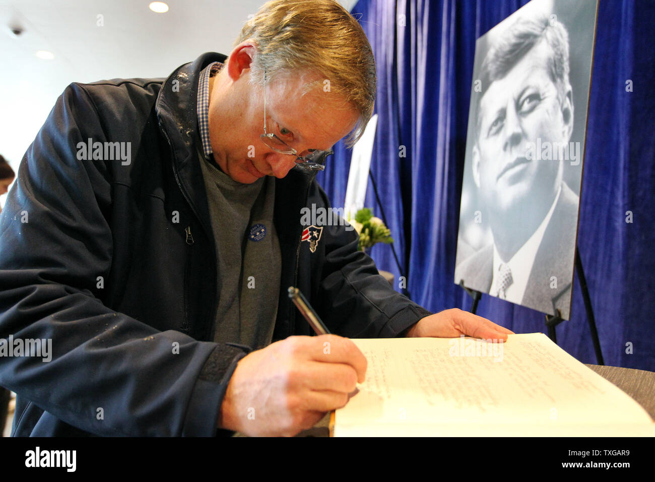 John Bates of Melrose, Massachusetts signs a memory book dedicated to ...