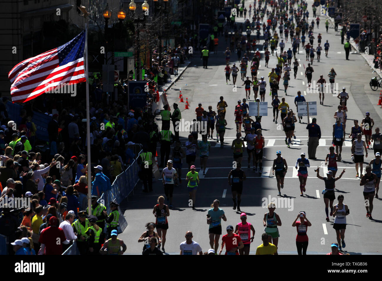 Runners make their way towards the finish line of the 118th Boston ...